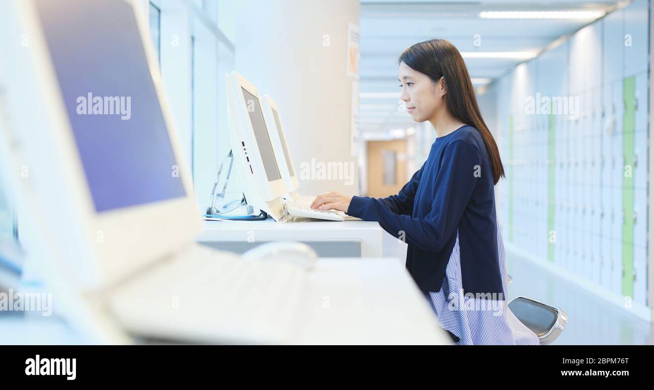 Student using computer inside university campus Stock Photo - Alamy