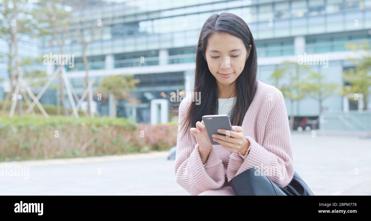 Woman working on mobile phone Stock Photo - Alamy