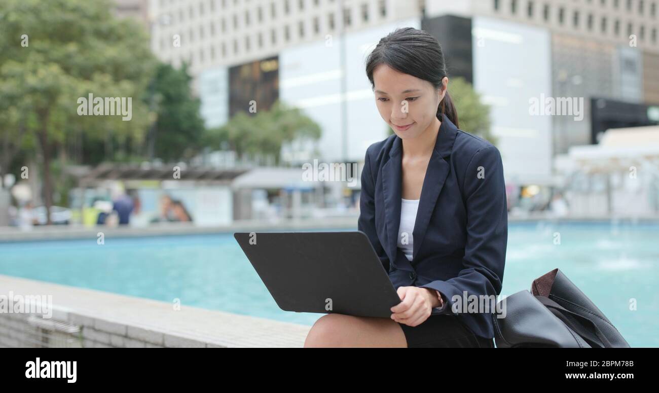 Businesswoman use of laptop computer at outdoor Stock Photo - Alamy
