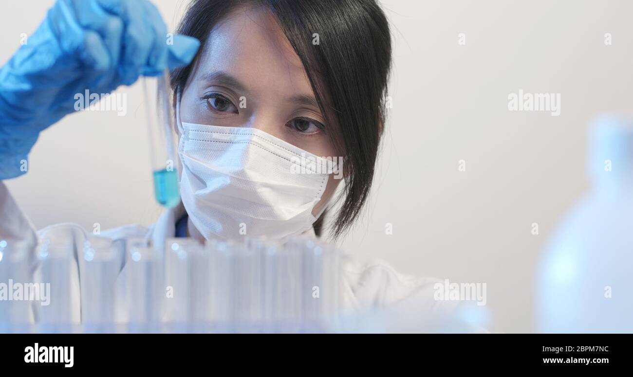 Scientist doing experiment with test tubes Stock Photo - Alamy