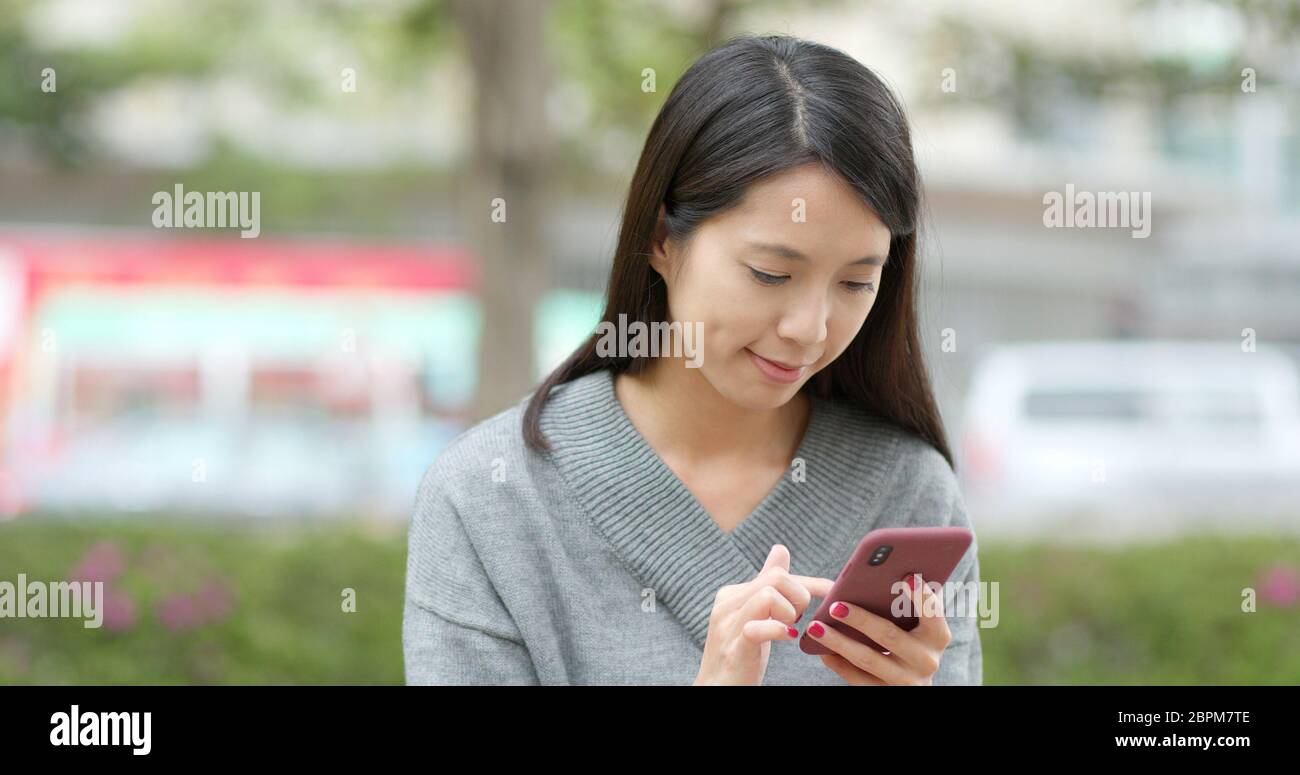 Woman use of mobile phone at outdoor Stock Photo - Alamy