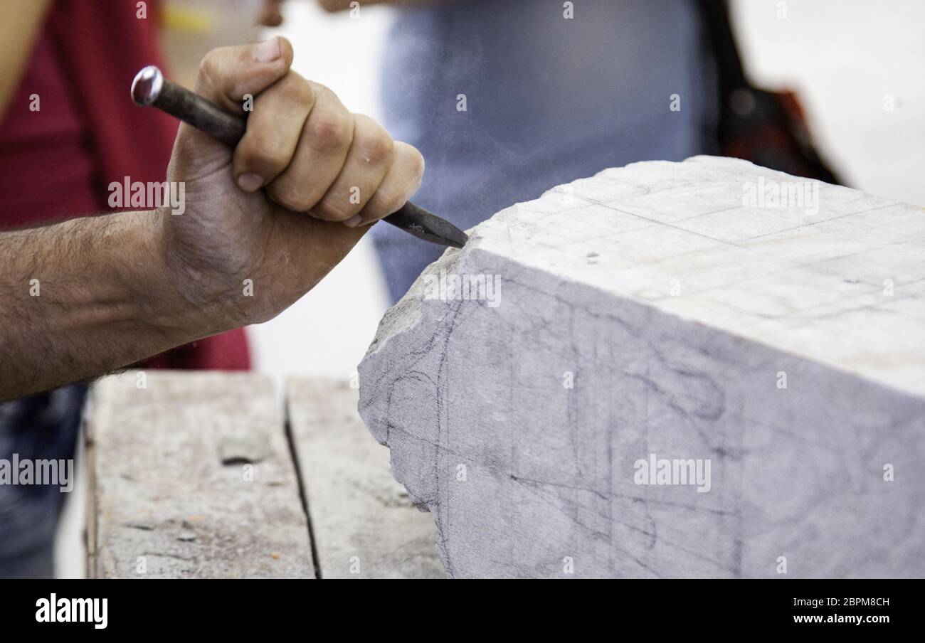 Carving stone, craftsman shaping stone, art and crafts Stock Photo - Alamy