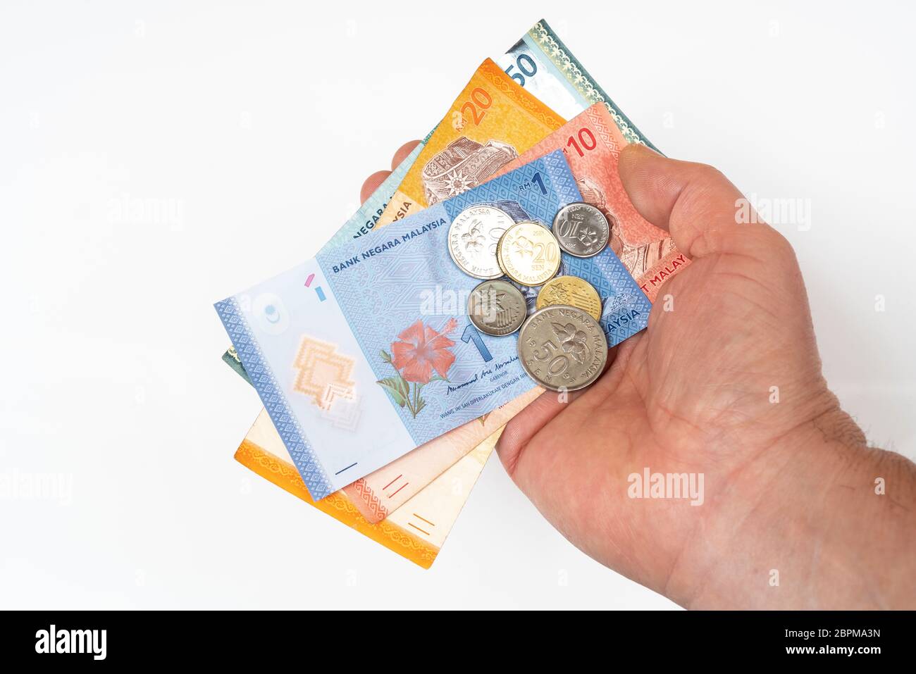 some Malaysian Ringgit banknotes and coins in the hand Stock Photo - Alamy