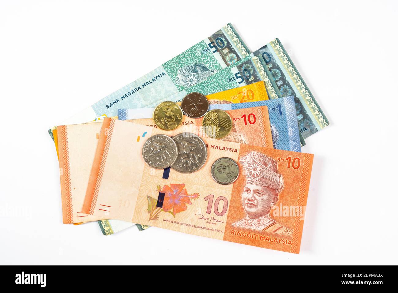 three 50 Malaysian Ringgit banknotes and coins on a white surface Stock ...