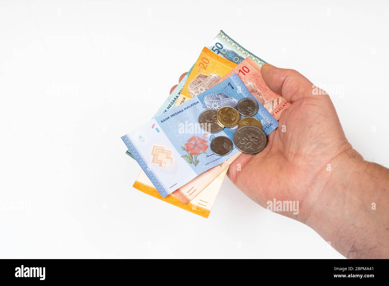 some Malaysian Ringgit banknotes and coins in the hand Stock Photo - Alamy