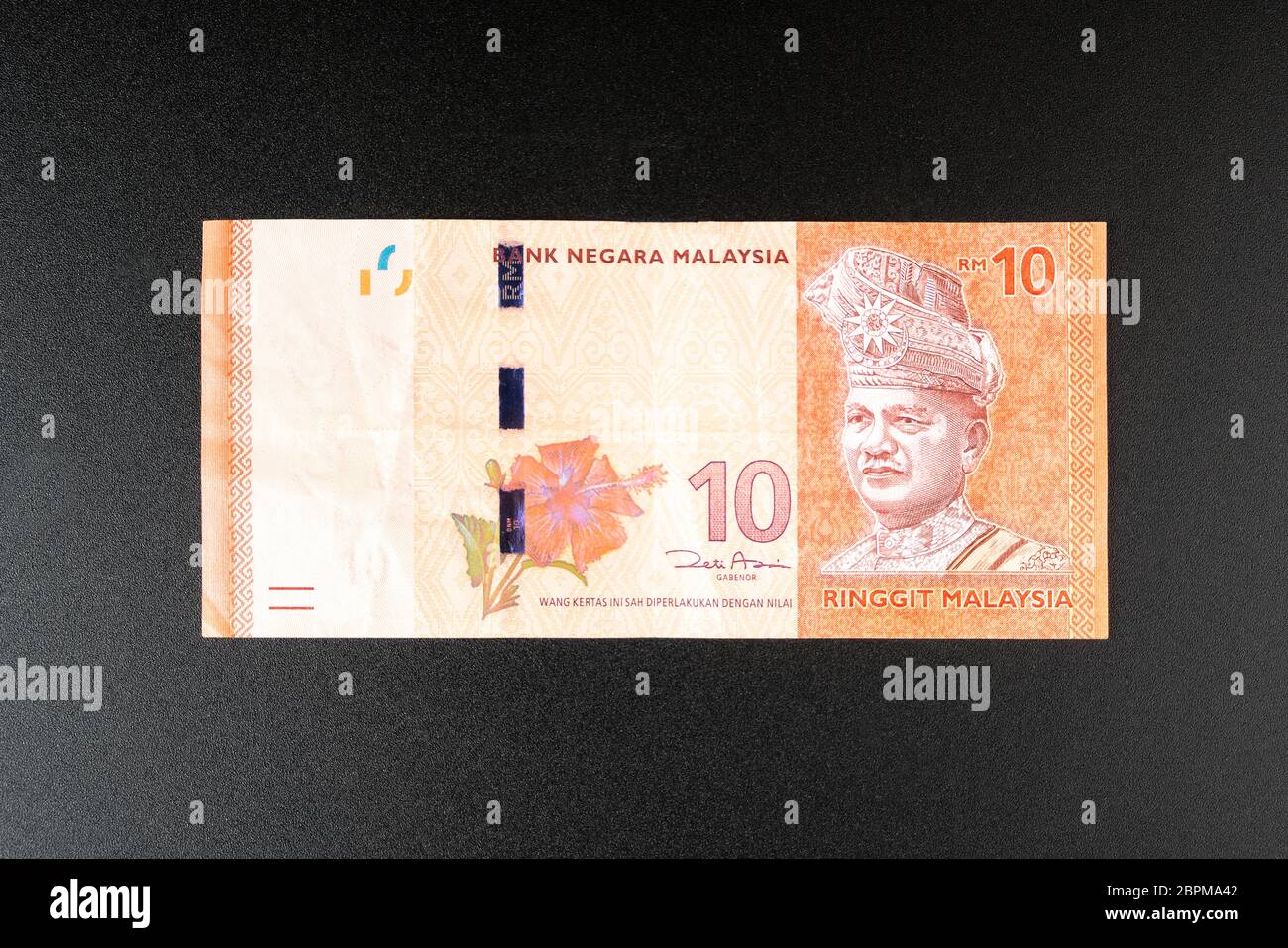 a 10 Malaysian Ringgit banknote on a black surface Stock Photo - Alamy