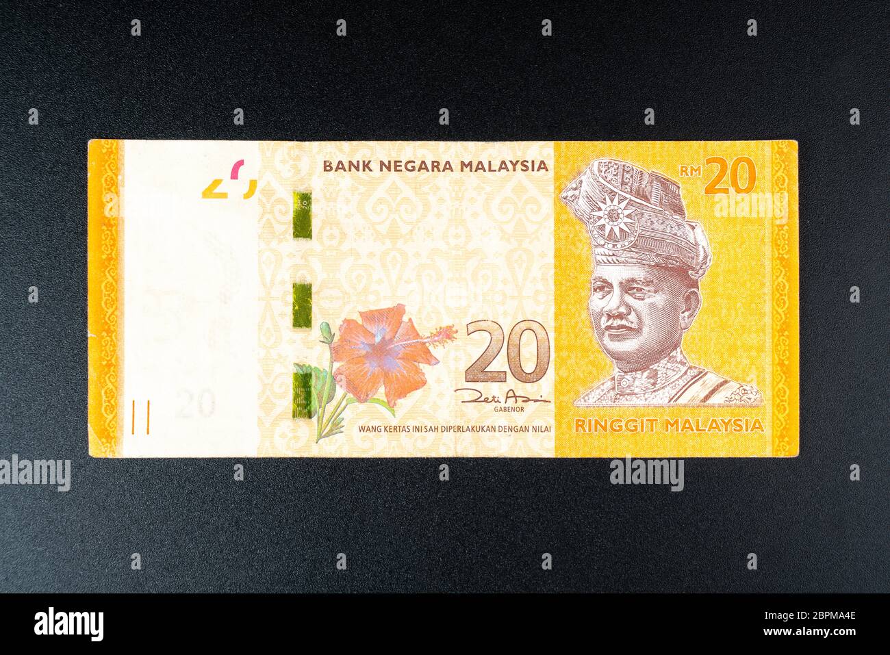 a 20 Malaysian Ringgit banknote on a black surface Stock Photo - Alamy