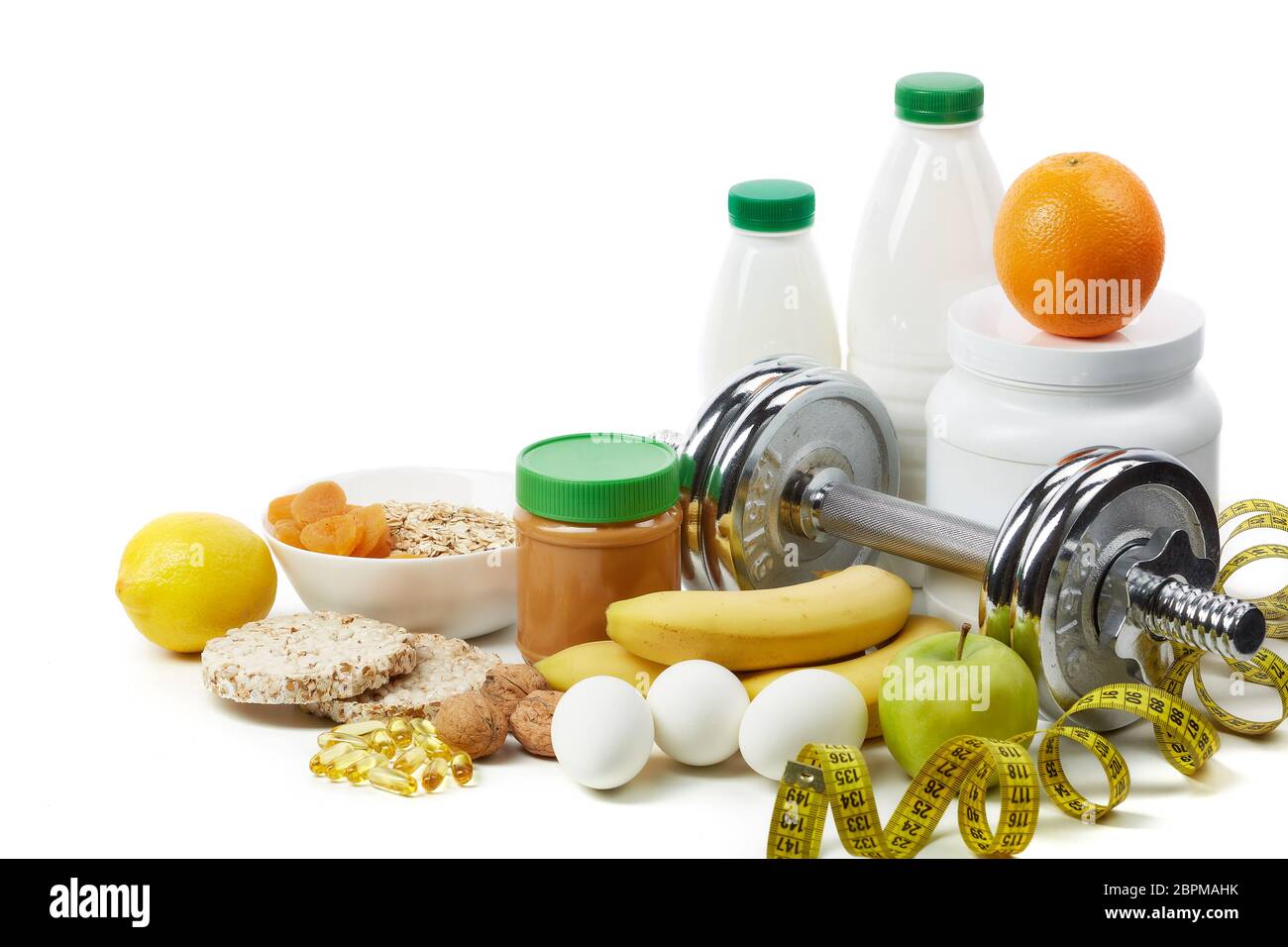 Sports nutrition (supplements), healthy food and dumbbells isolated on ...
