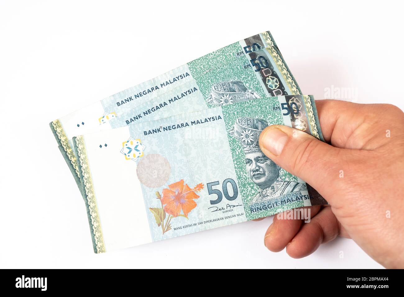 three 50 Malaysian Ringgit banknotes in the hand Stock Photo - Alamy