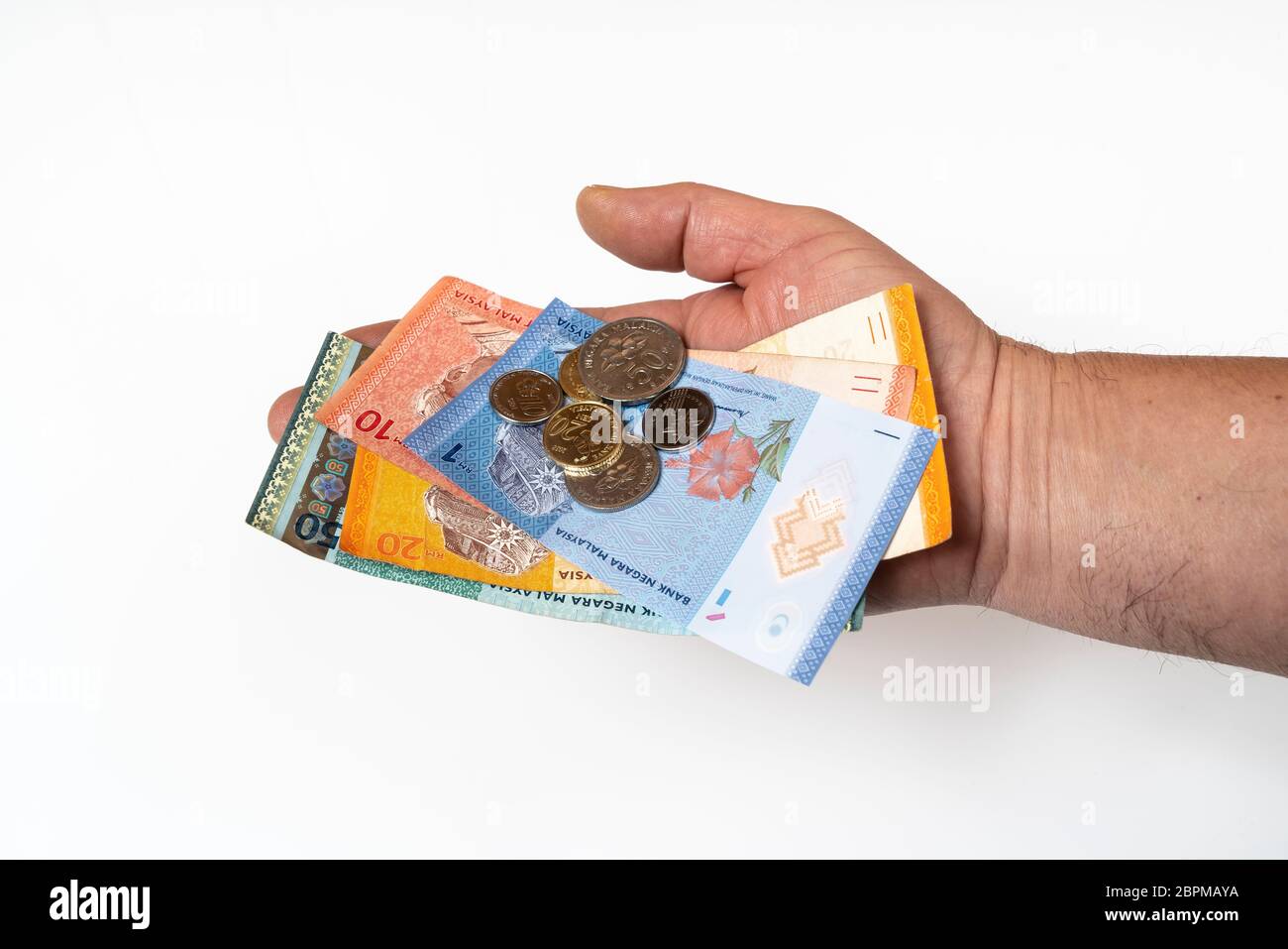 some Malaysian Ringgit banknotes and coins in the hand Stock Photo - Alamy