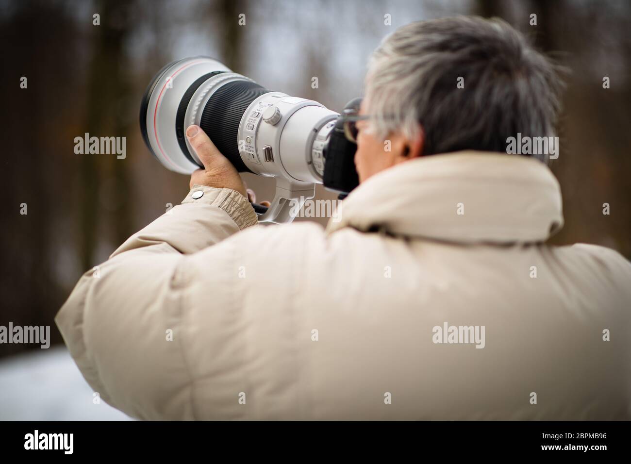 Senior man devoting time to his favorite hobby - photography - taking ...