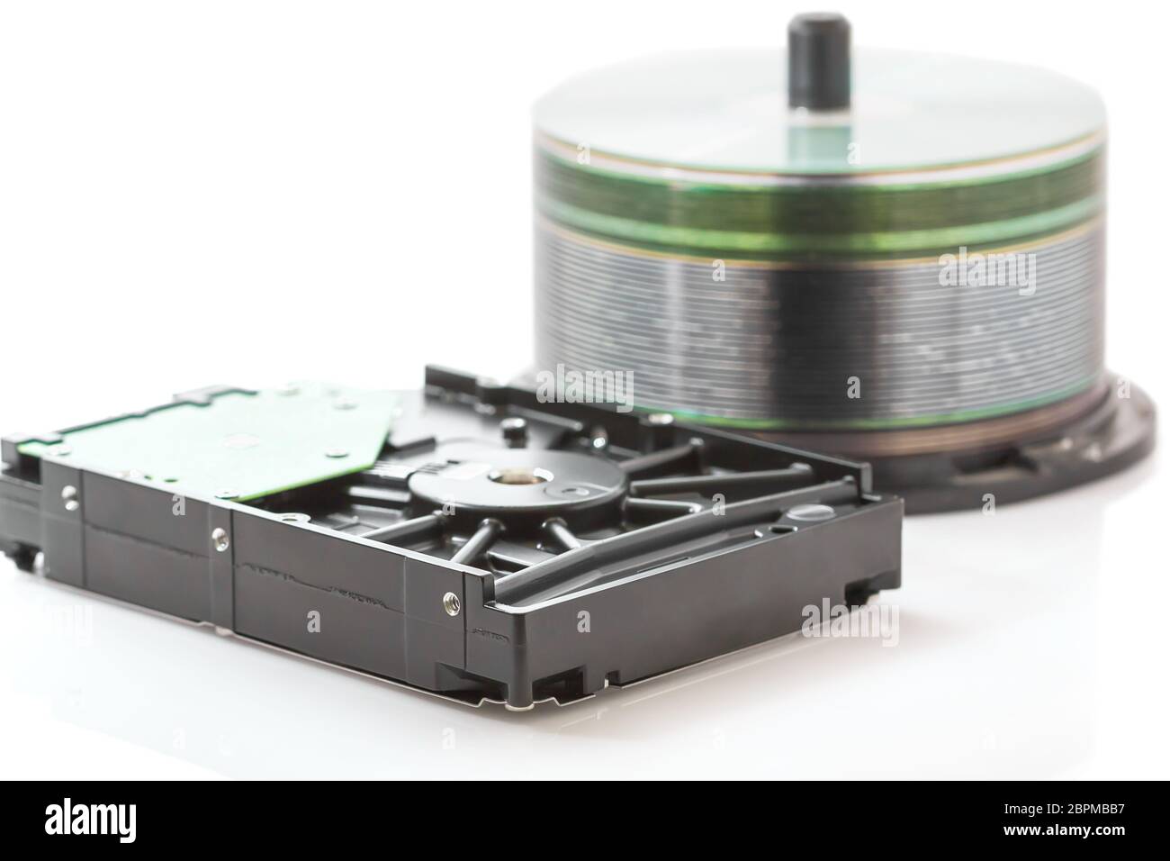 Hard disk drive (HDD) with circuit board and compact discs on white ...