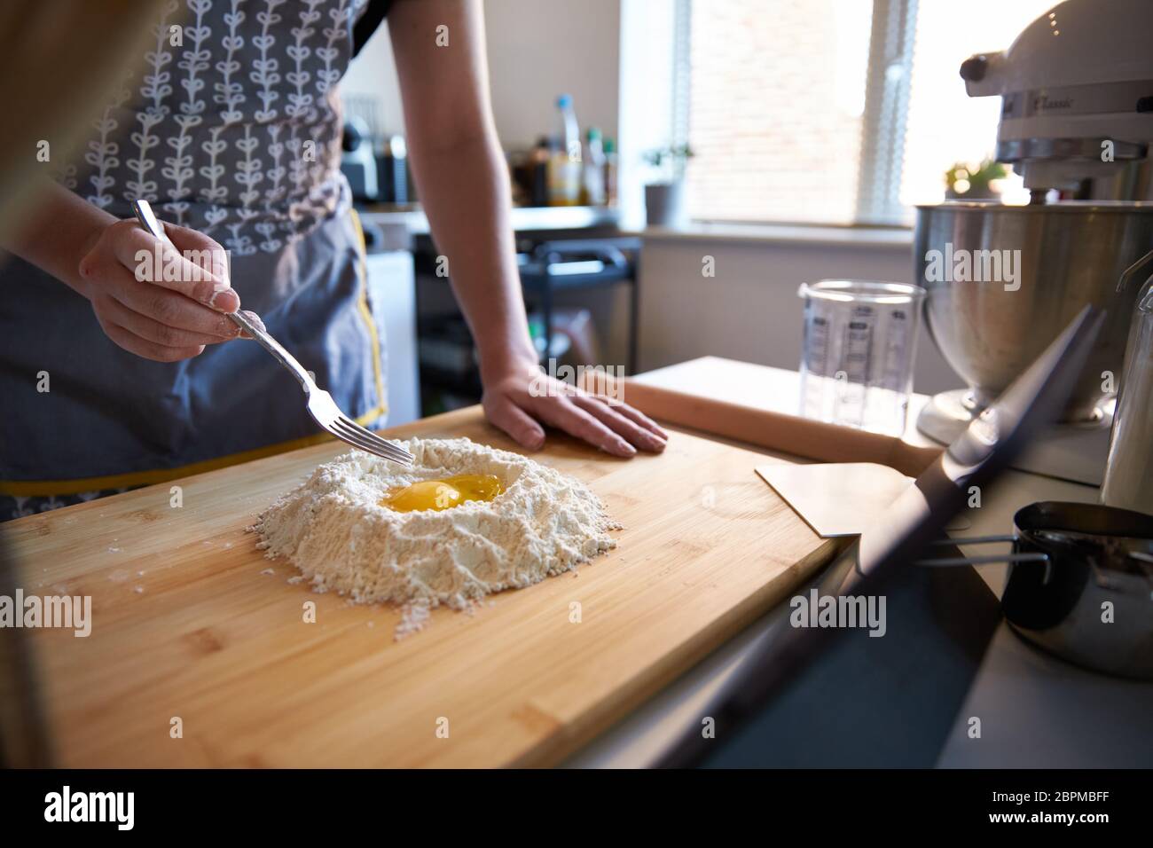 Anonymous Person Making Fresh Pasta At Home in The Kitchen, Watching A ...