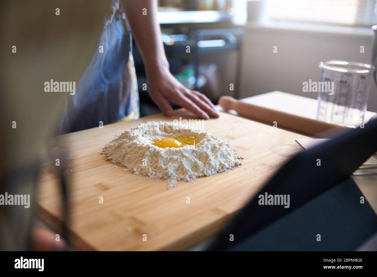 Anonymous Person Making Fresh Pasta At Home in The Kitchen, Watching A ...