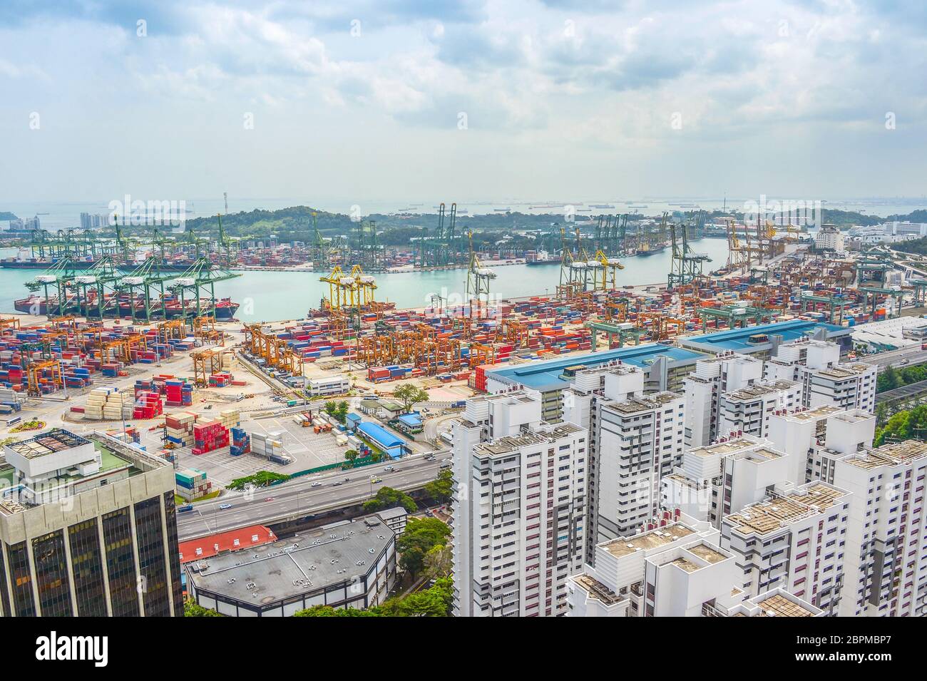 Aerial view of Singapore cargo shipping port with freight cranes and ...