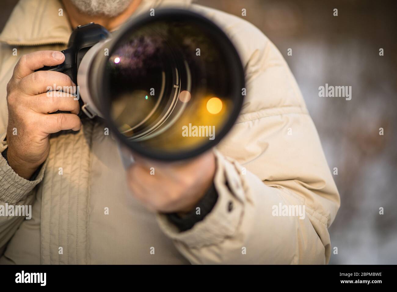 Senior man devoting time to his favorite hobby - photography - taking ...