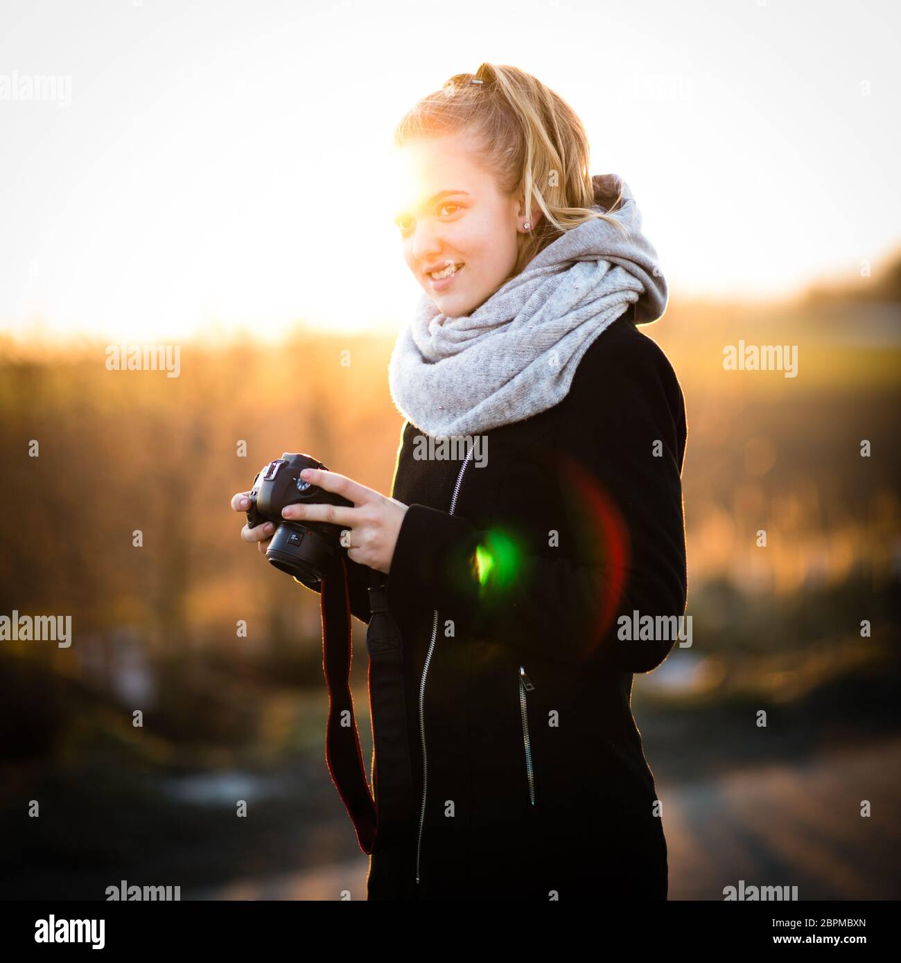 Cute female photographer with her dslr camera taking photos outdoor at ...