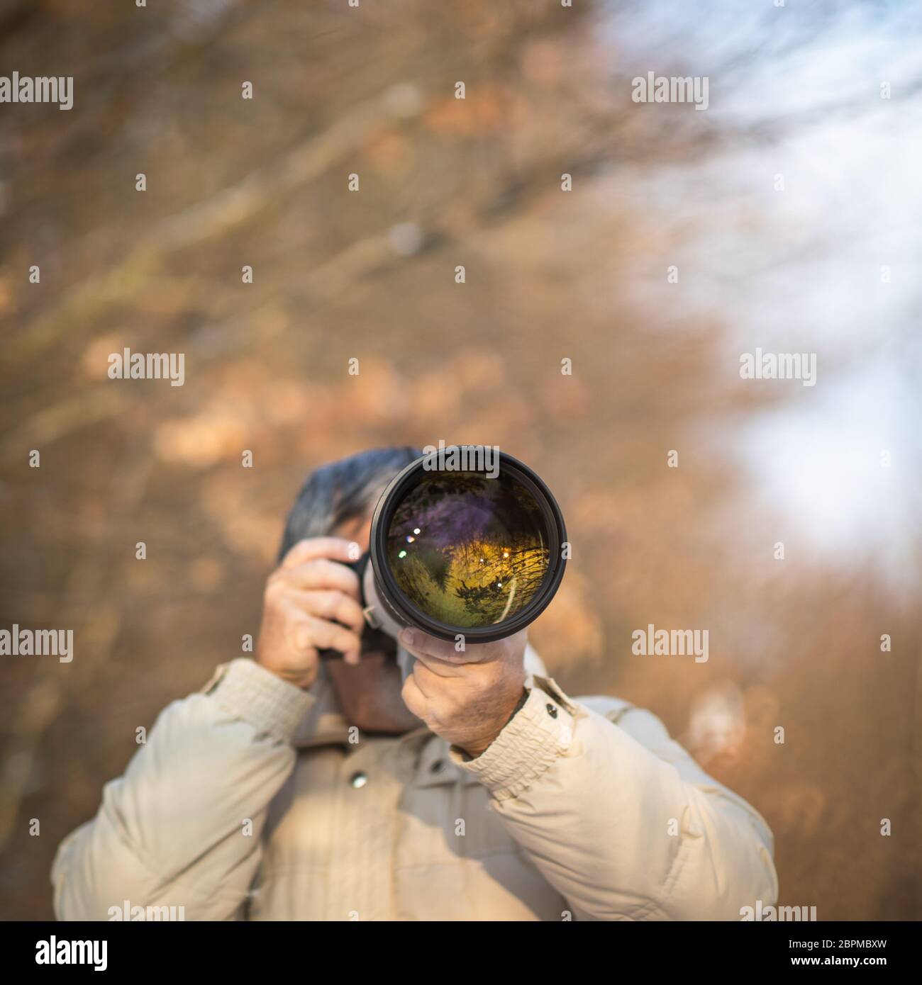 Senior man devoting time to his favorite hobby - photography - taking ...
