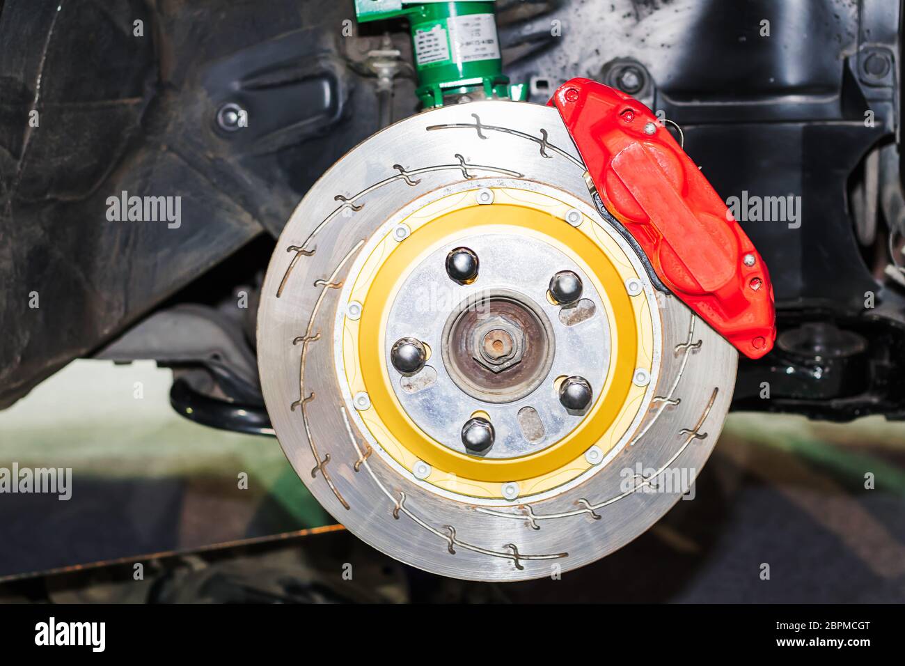 Front disk brake system on car in process of damaged tyre replacement ...