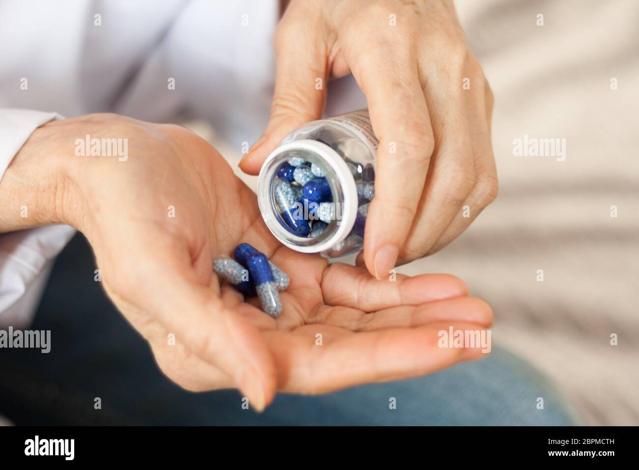 Female hand close up holding a medicine, elderly woman hands with pill ...