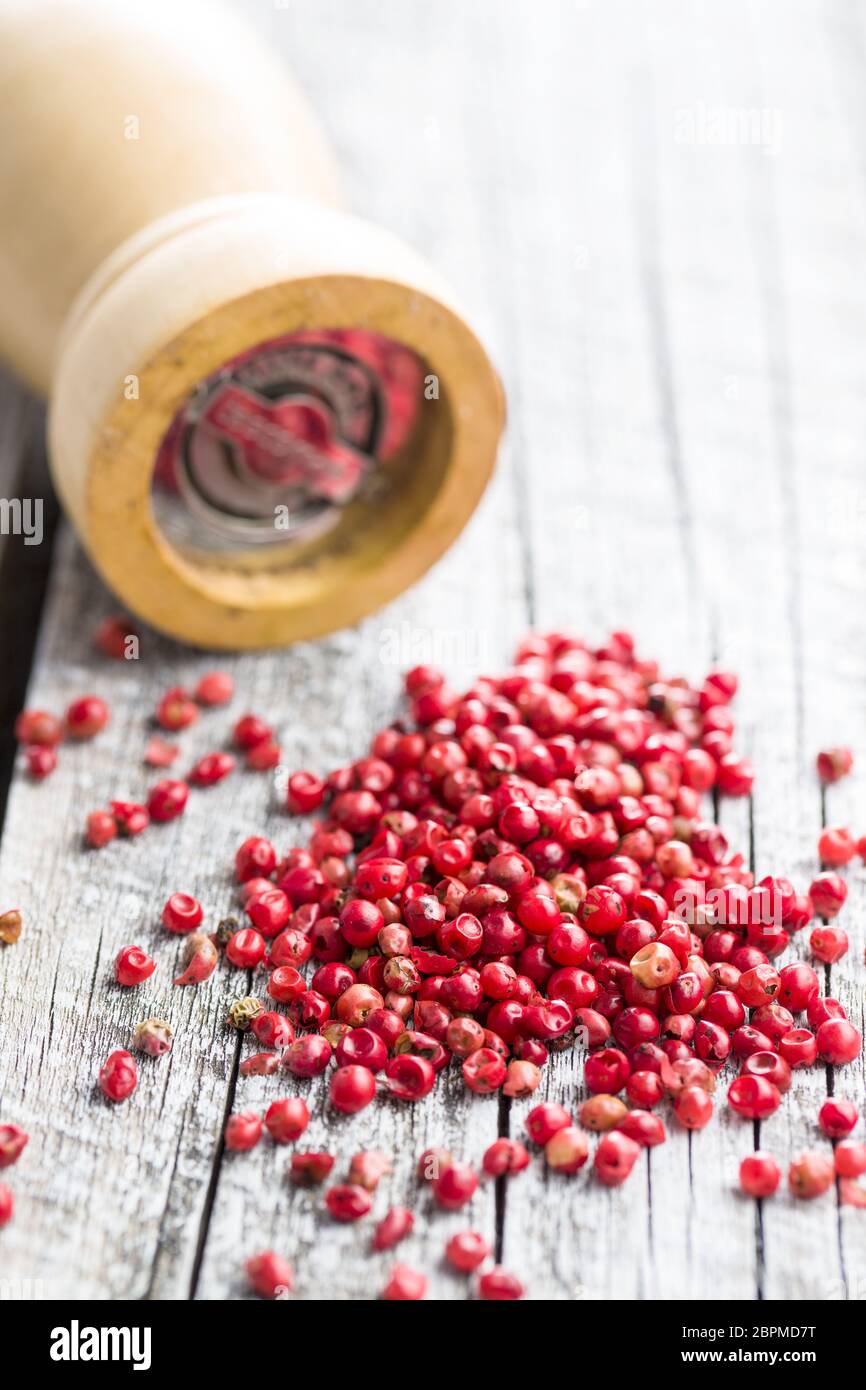 Dried pink peppercorn on old wooden table Stock Photo - Alamy