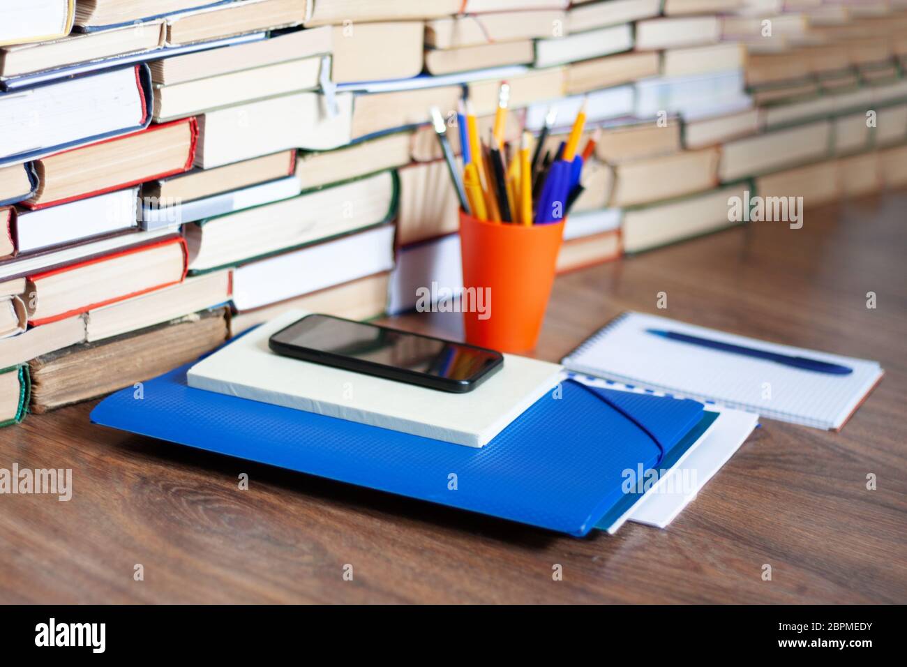 Textbook, notebook, mobile phone smartphone, stack of books. Home ...