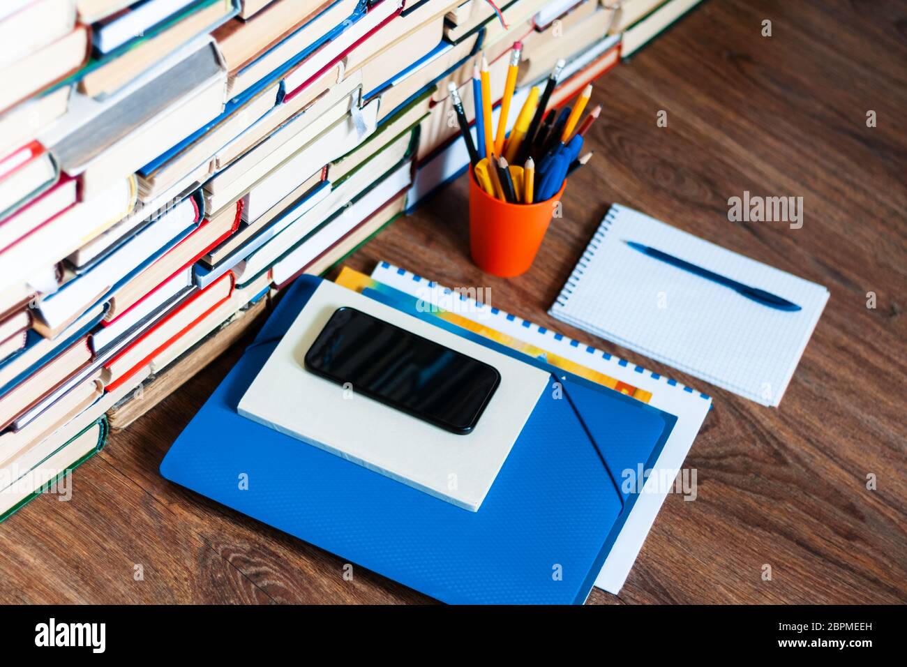 Textbook, notebook, mobile phone smartphone, stack of books. Home ...