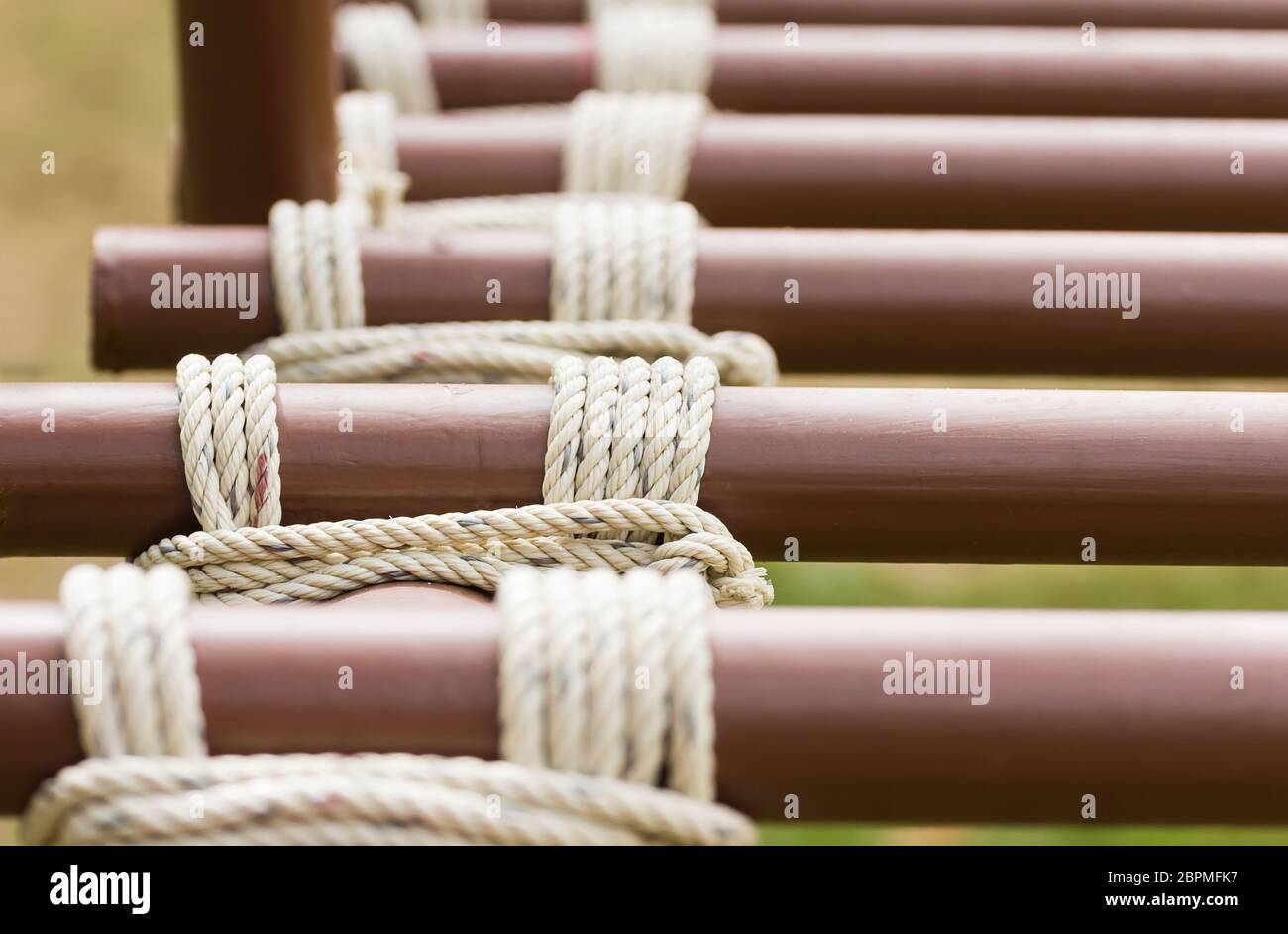Close up of rope tied knot around metal pipe Stock Photo - Alamy