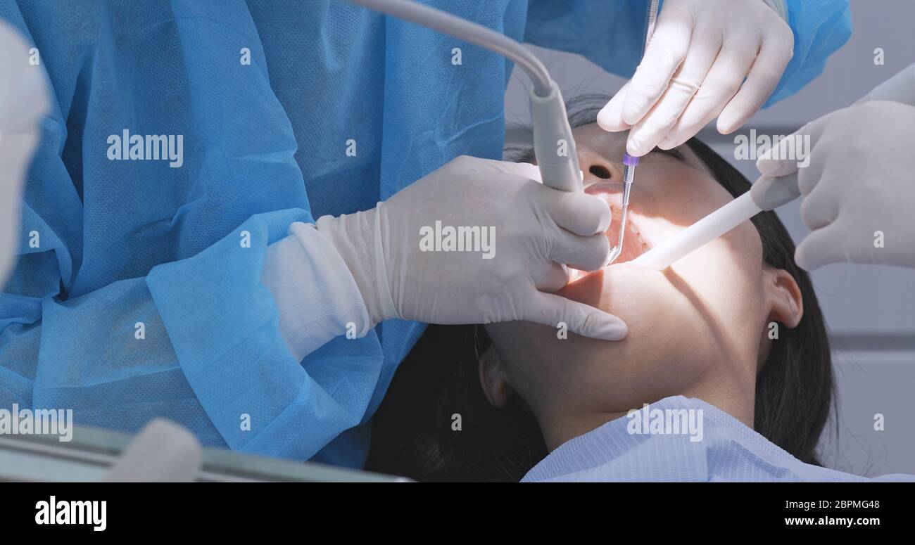 Dentist examining woman teeth Stock Photo - Alamy