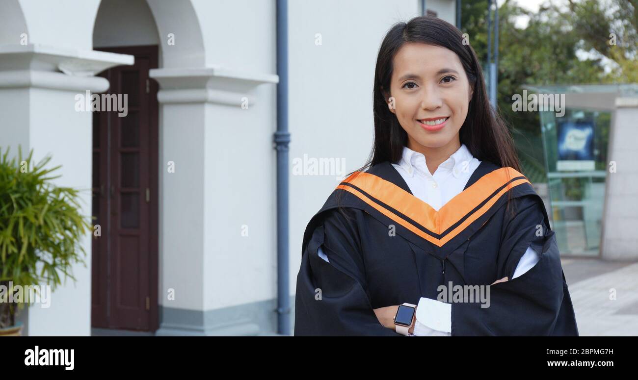 Woman wearing graduation gown Stock Photo - Alamy