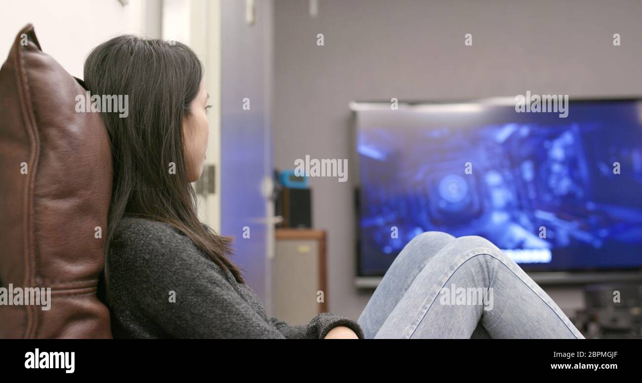 Woman watching tv at home Stock Photo - Alamy