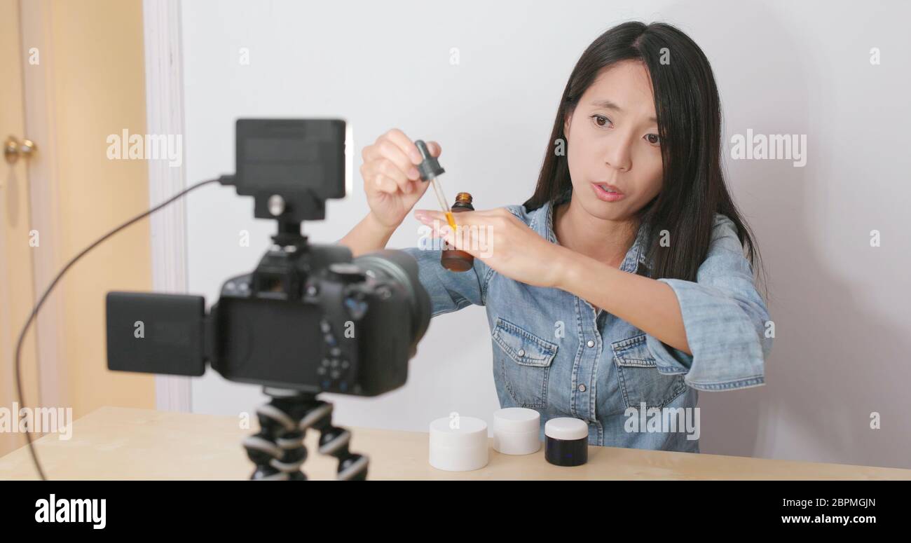 Woman taking video of showing the cosmetic product at home Stock Photo ...