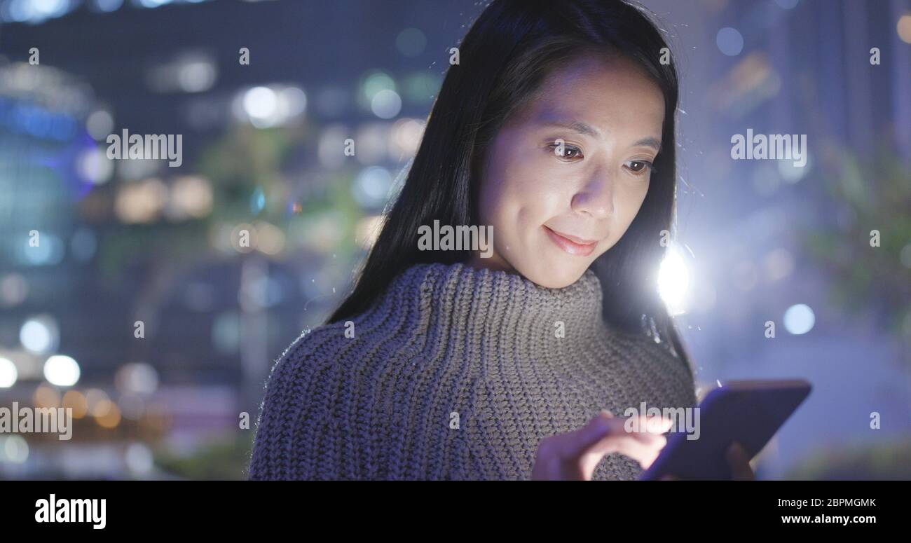 Woman use of mobile phone at night Stock Photo - Alamy