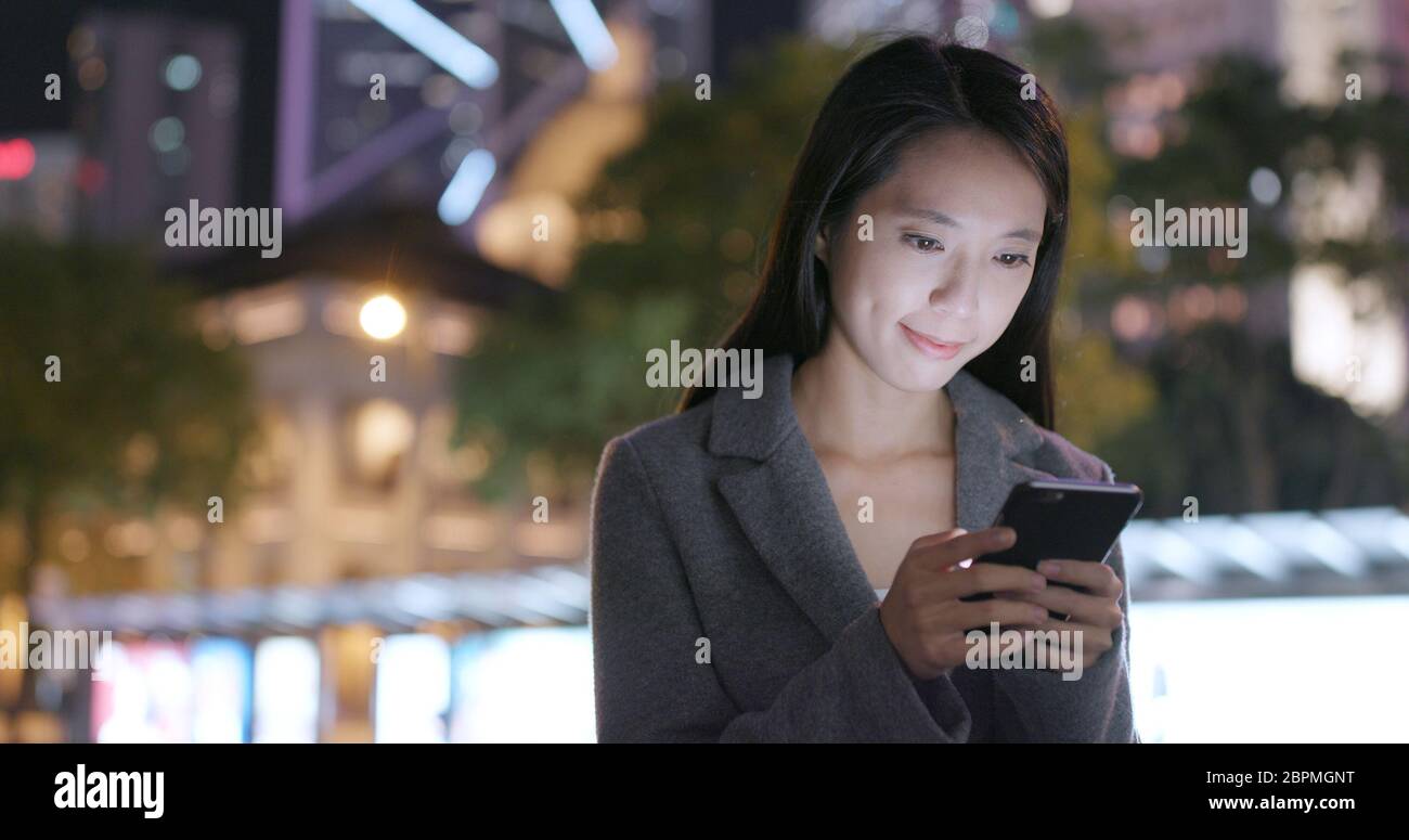 Woman watch on cellphone night hi-res stock photography and images - Alamy