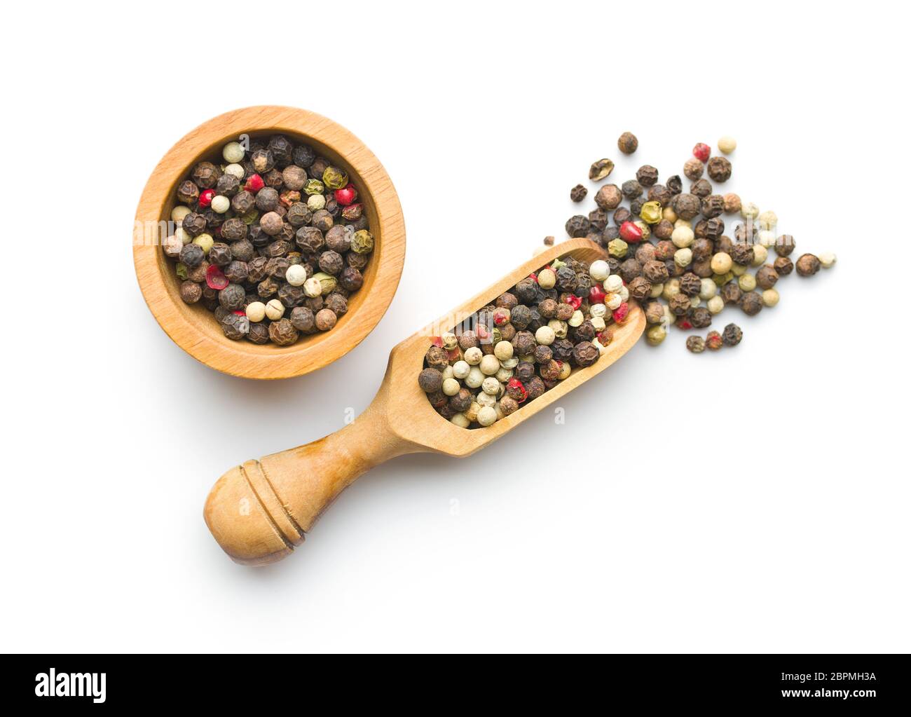 Different types of dried peppercorn in scoop isolated on white ...