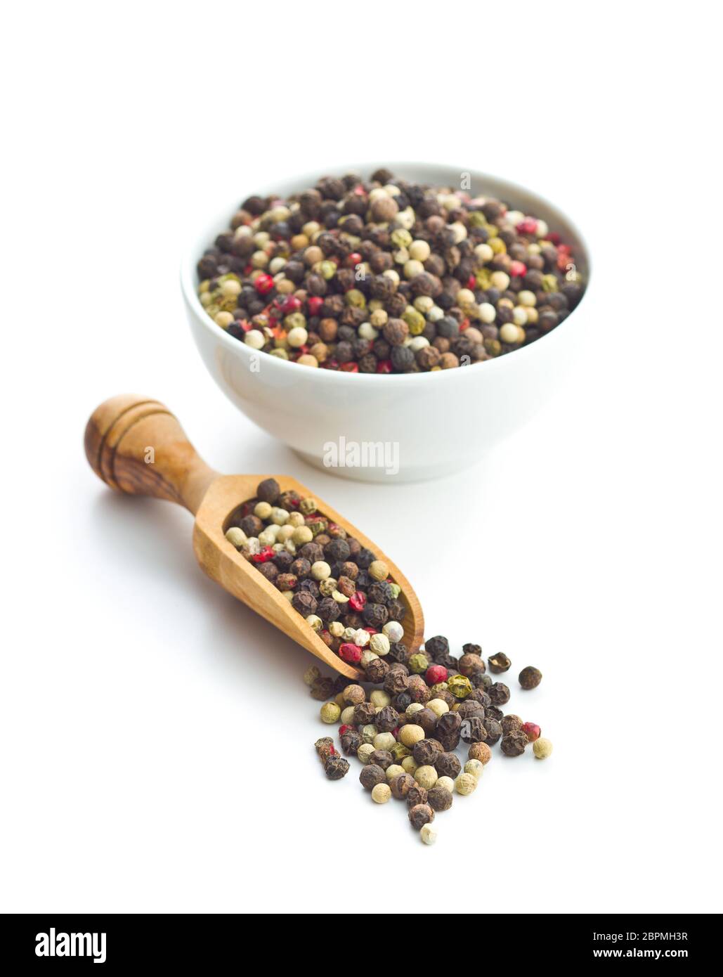 Different types of dried peppercorn in scoop isolated on white ...