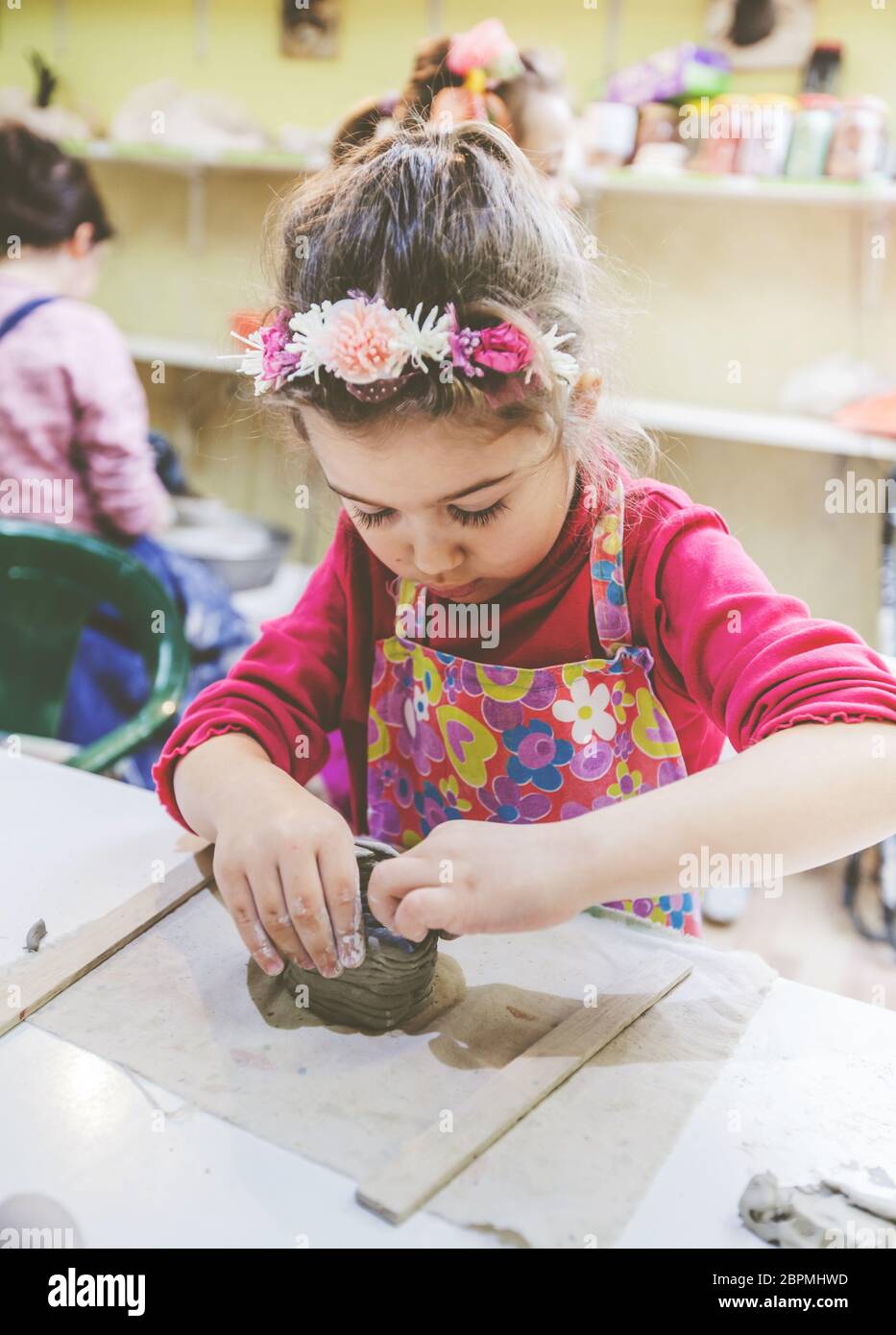 Child pottery workshop, little girl working with clay, creative ...