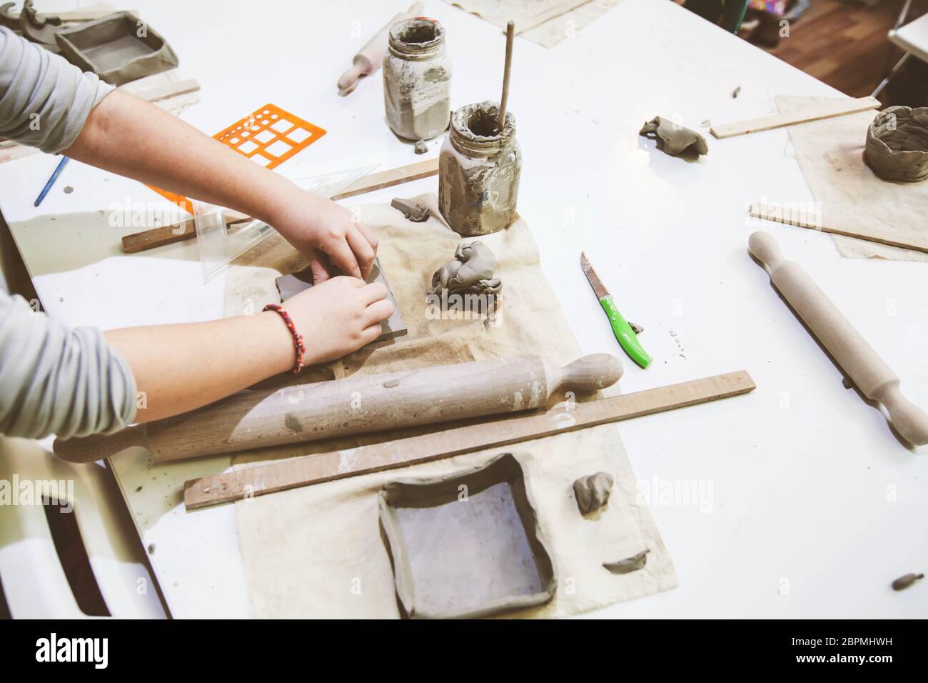 Little artist hands working with clay at pottery workshop Stock Photo ...
