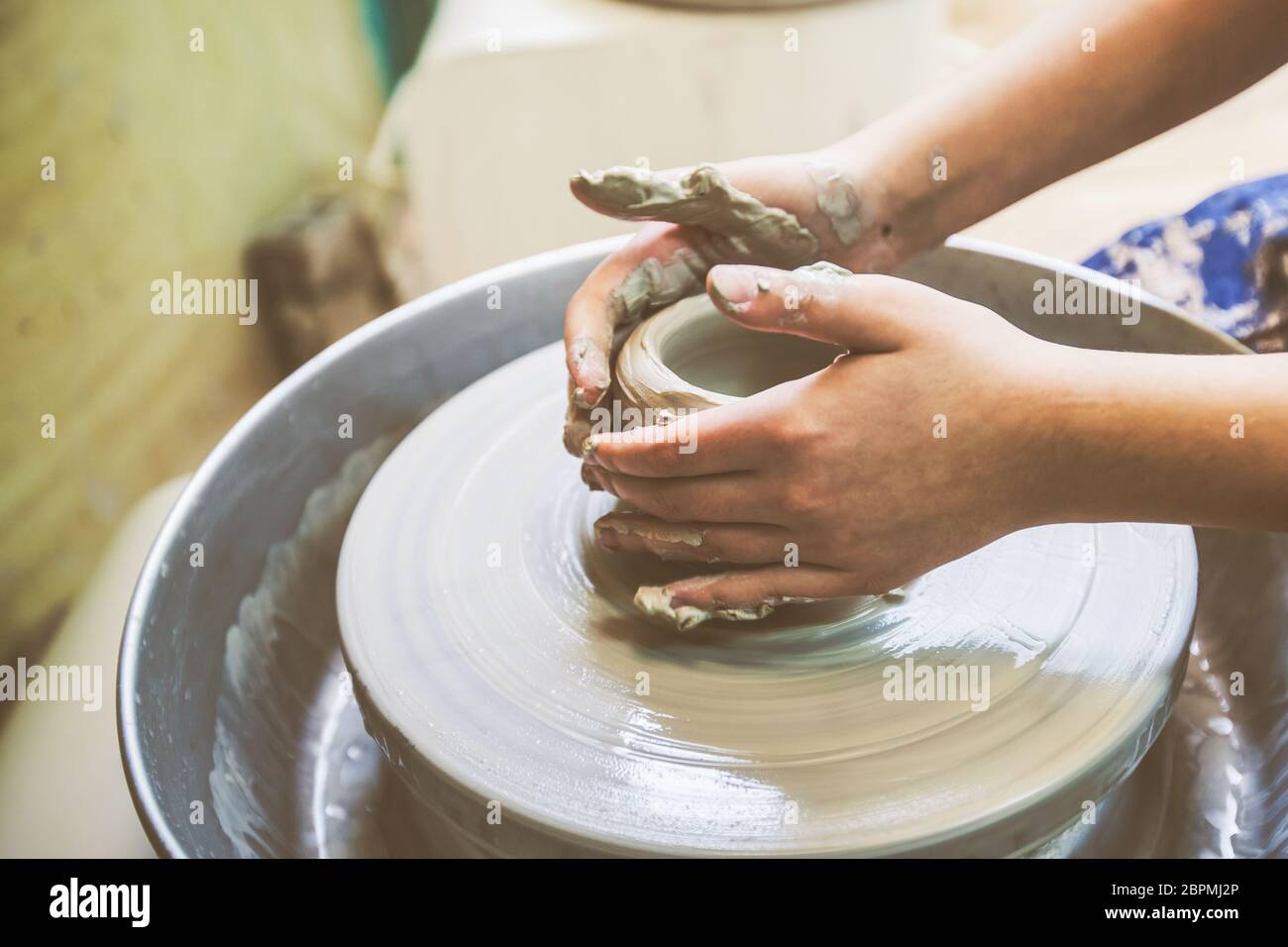 Child hands shaping clay on pottery wheel at workshop Stock Photo - Alamy