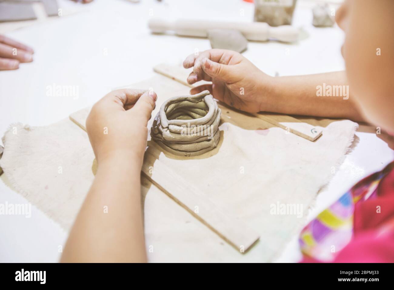Little artist hands working with clay at pottery workshop Stock Photo ...