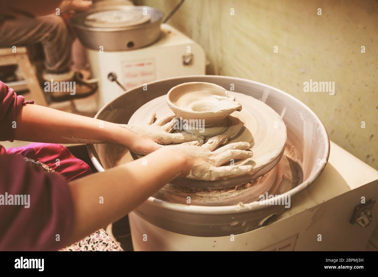 Child hands shaping clay on pottery wheel at workshop Stock Photo - Alamy