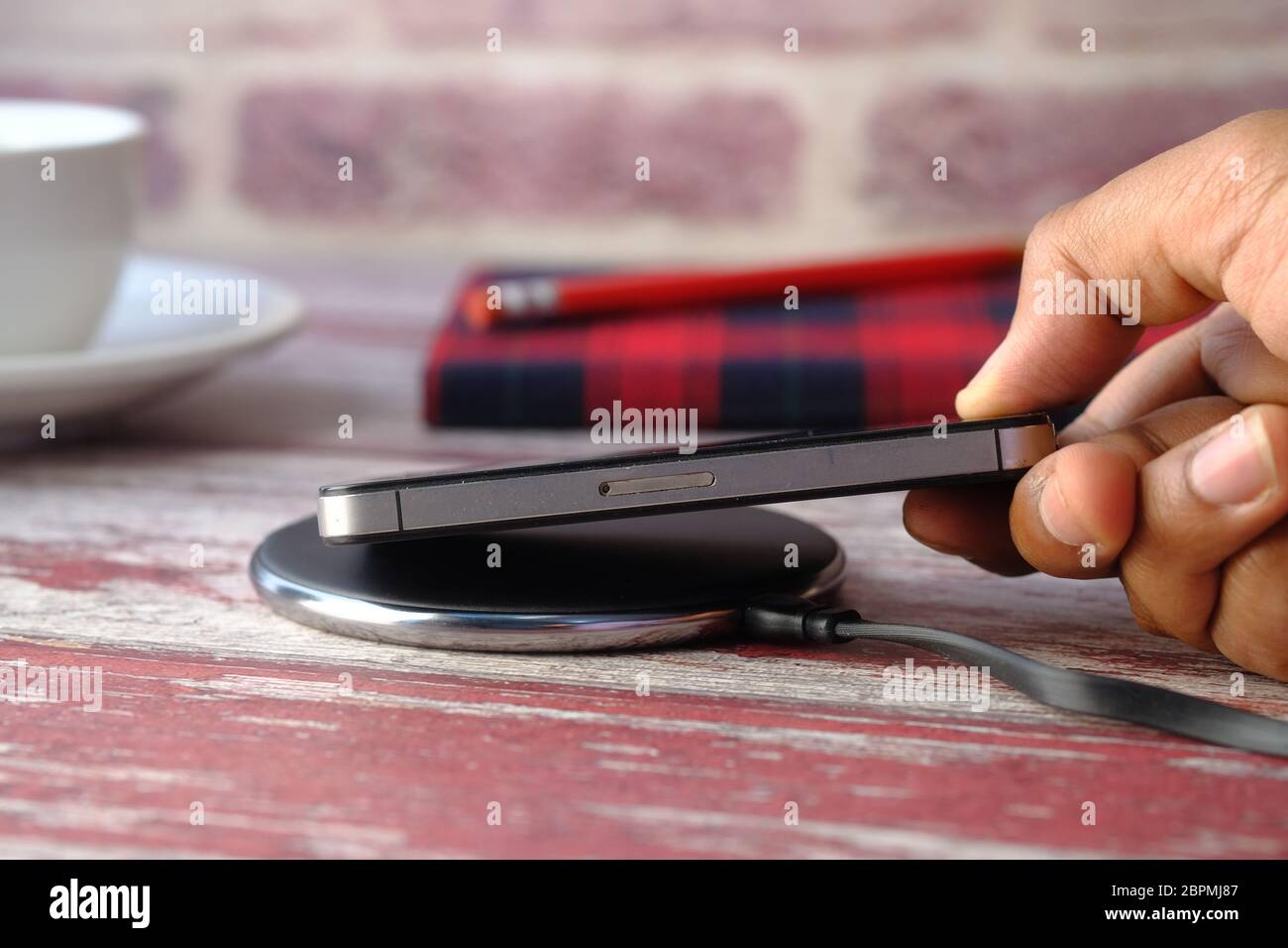 charging Smartphone Using Wireless Charging Pad, top view Stock Photo ...