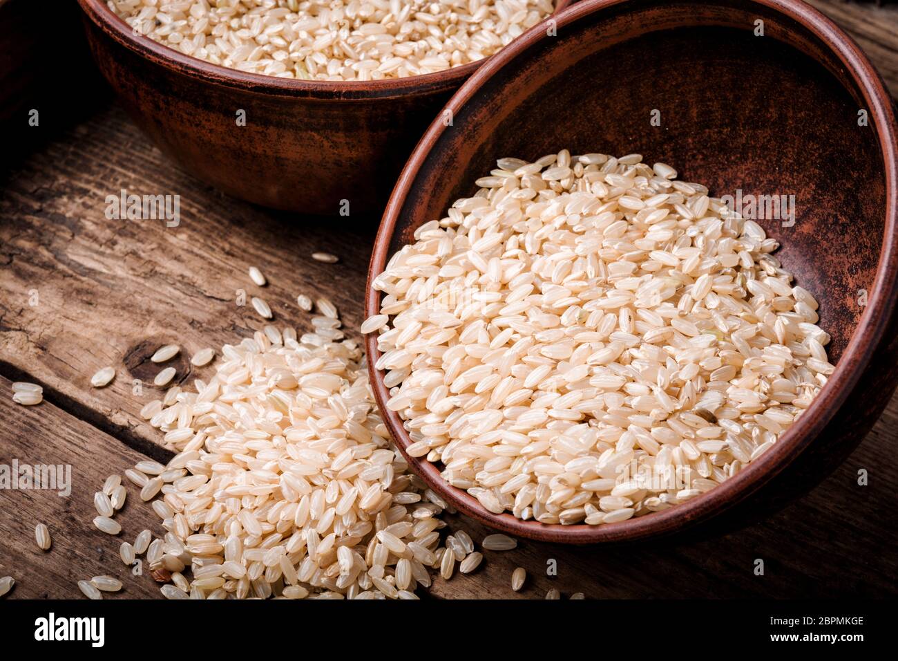 Raw grain white rice in a ceramic bowl.Healthy food Stock Photo - Alamy