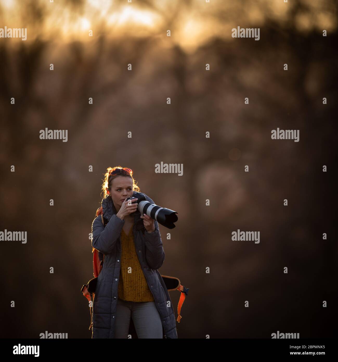 Cute female photographer with her dslr camera taking photos outdoor at ...