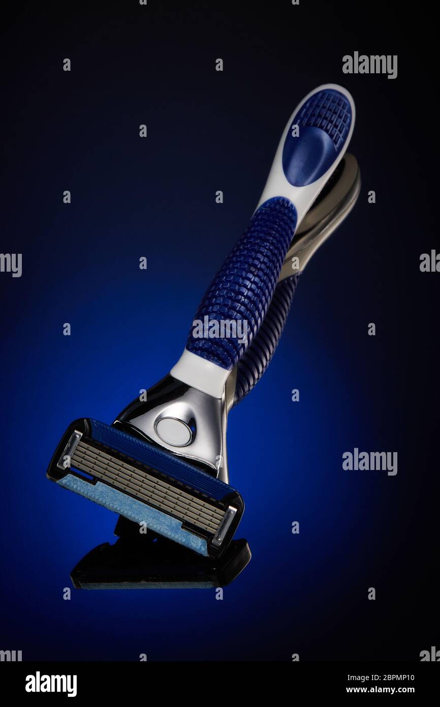 Modern blue razor for men on black background with blue lighting and ...