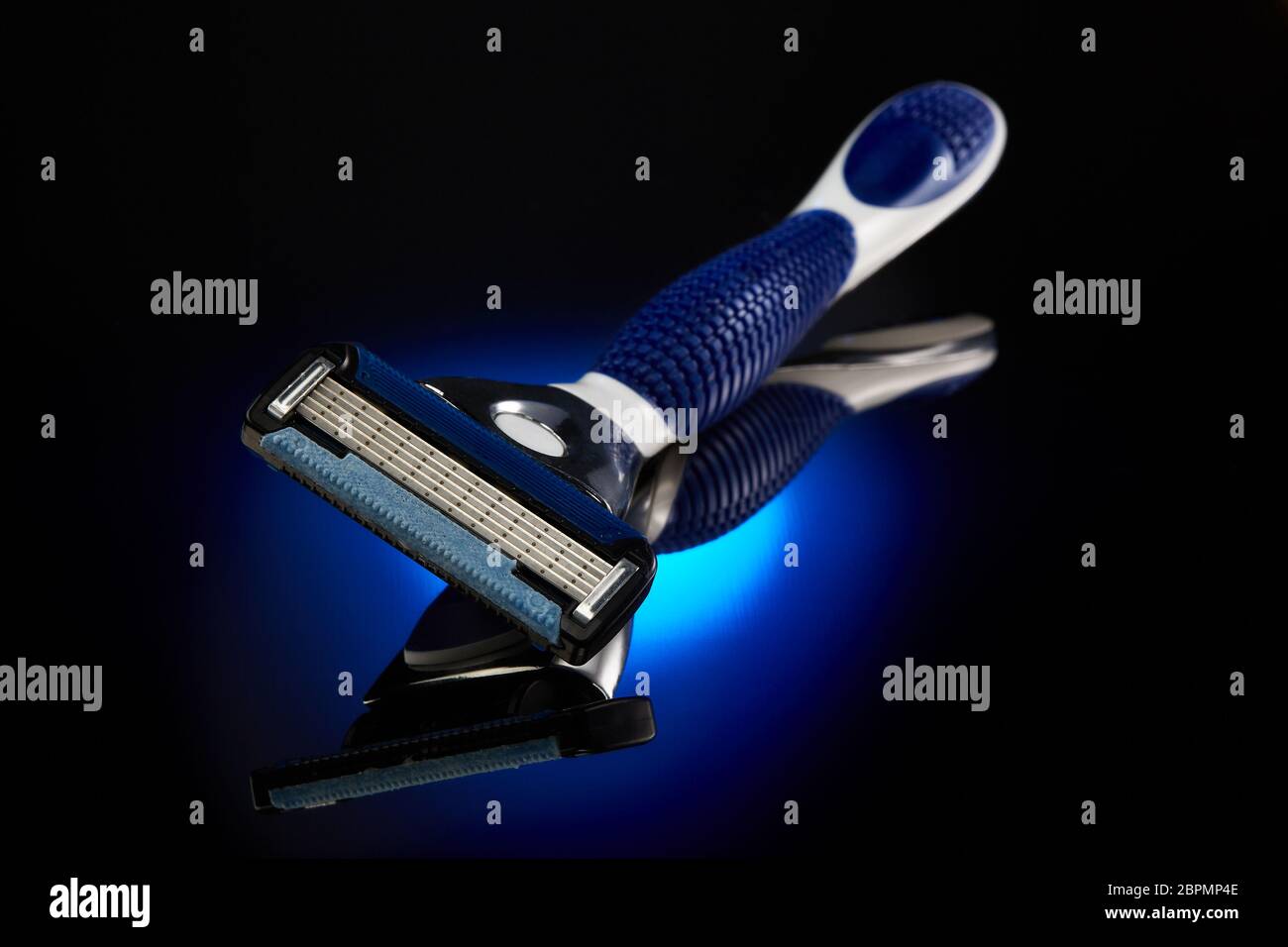 Modern blue razor for men on black background with blue lighting and ...