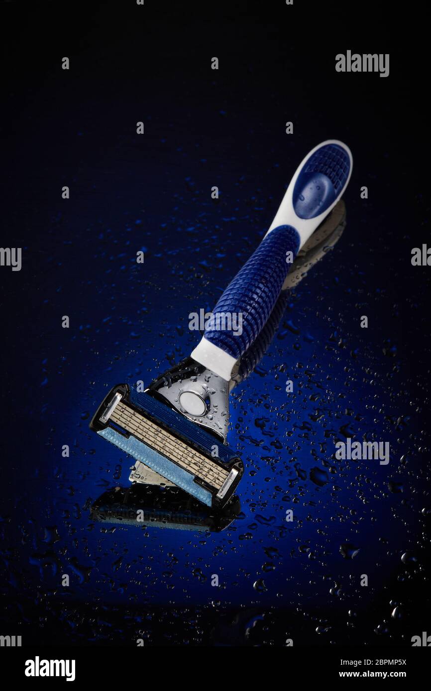 Modern blue razor for men on black background with blue lighting and ...