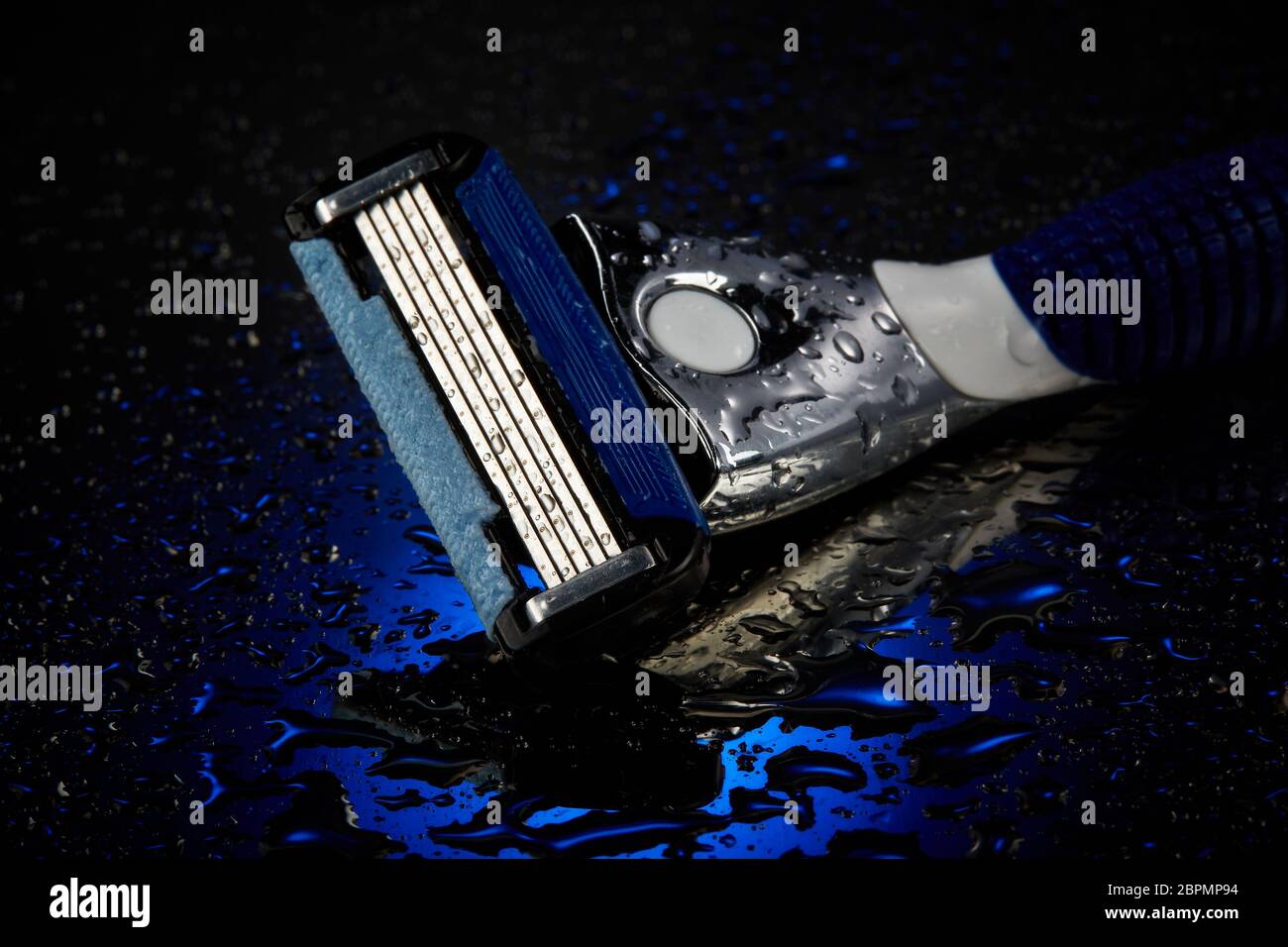 Modern blue razor for men on black background with blue lighting and ...