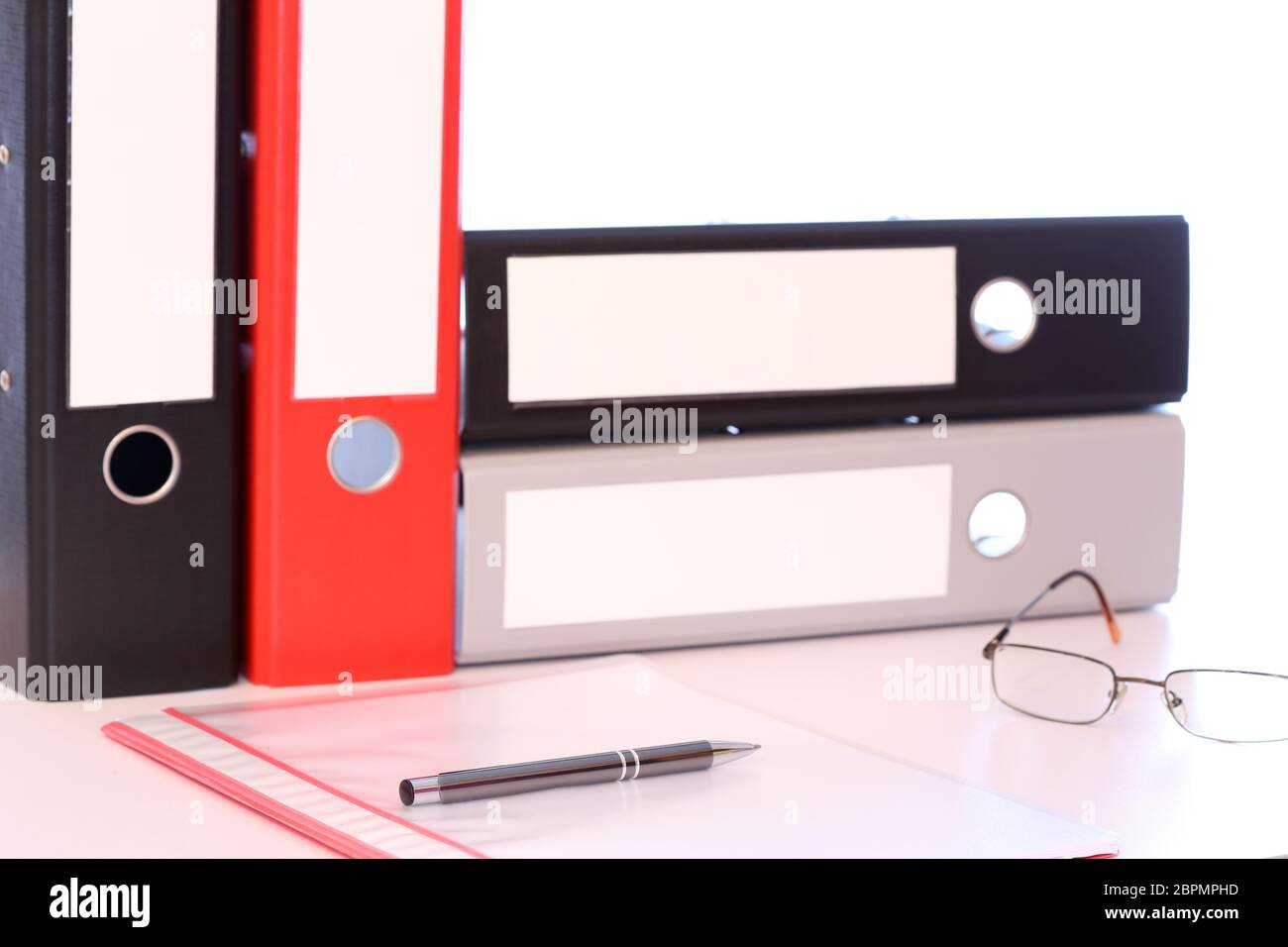 workplace in an office with binders and documents Stock Photo - Alamy