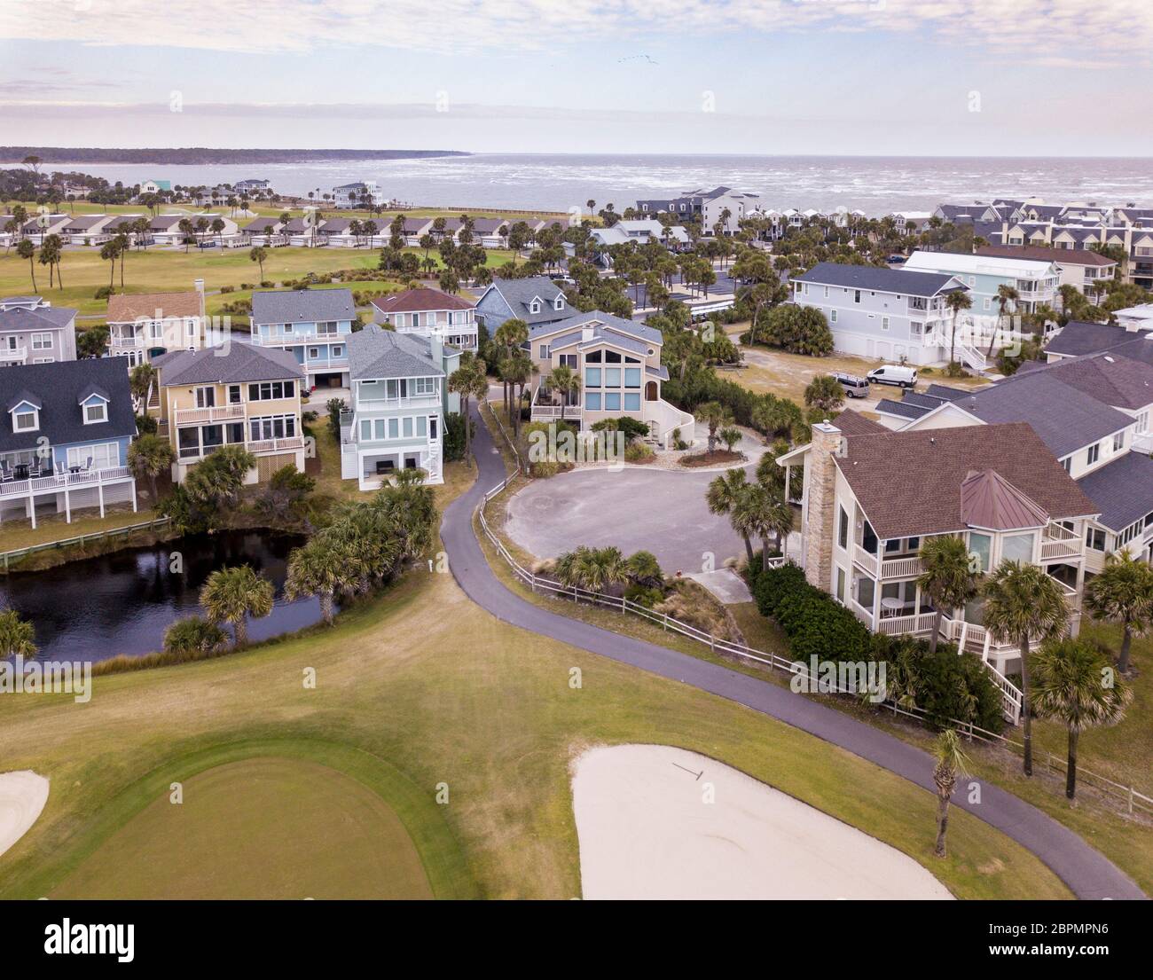 Aerial view of houses and golf course along the shore of Fripp Island ...